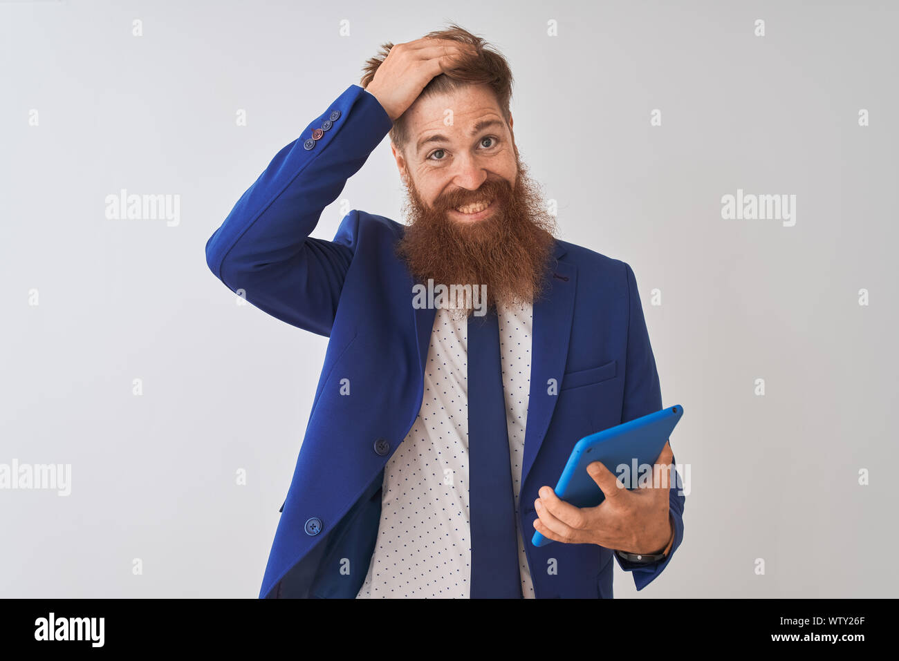 Young redhead irish businessman using tablet over isolated white ...