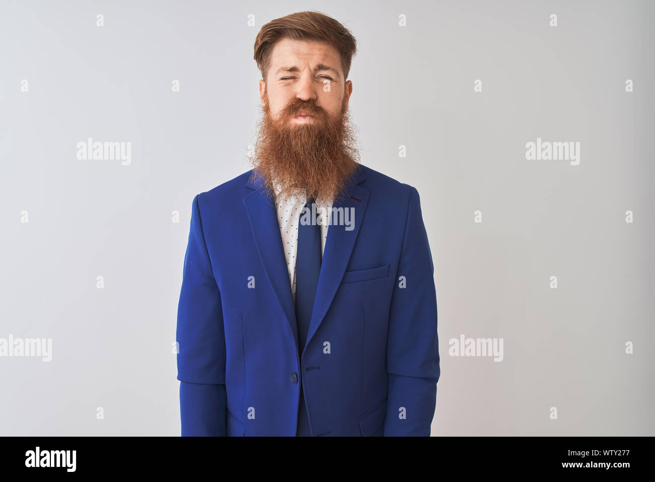 Young redhead irish businessman wearing suit standing over isolated ...