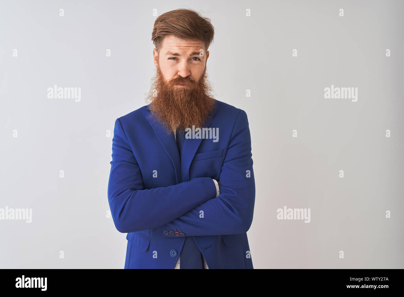 Young redhead irish businessman wearing suit standing over isolated ...