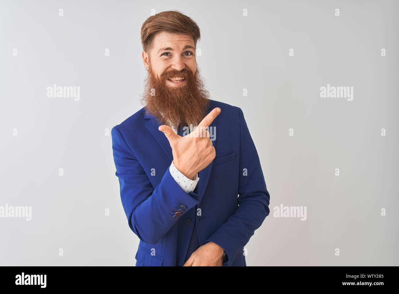 Young redhead irish businessman wearing suit standing over isolated ...