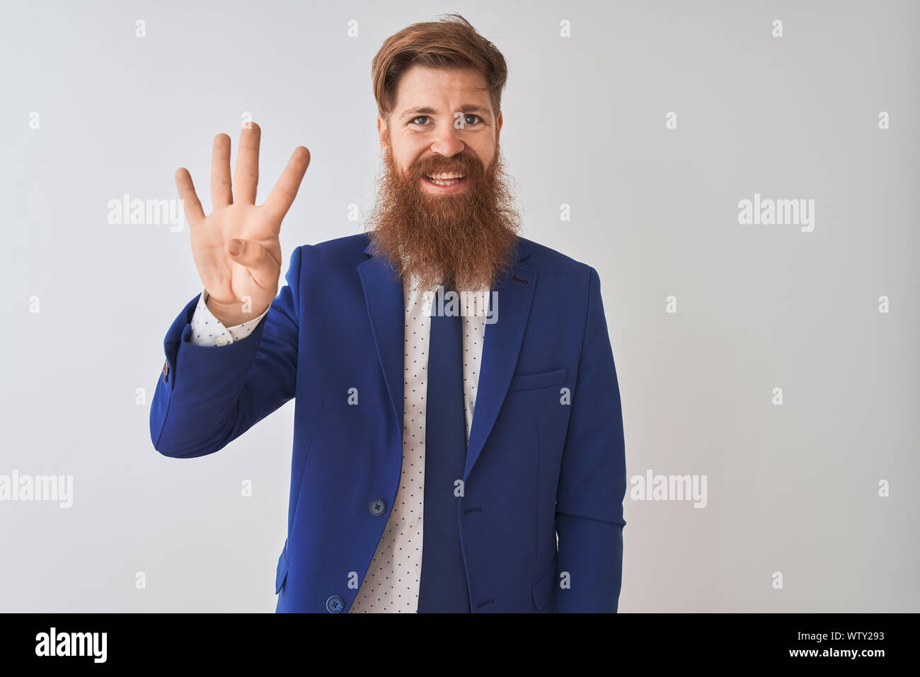 Young redhead irish businessman wearing suit standing over isolated ...