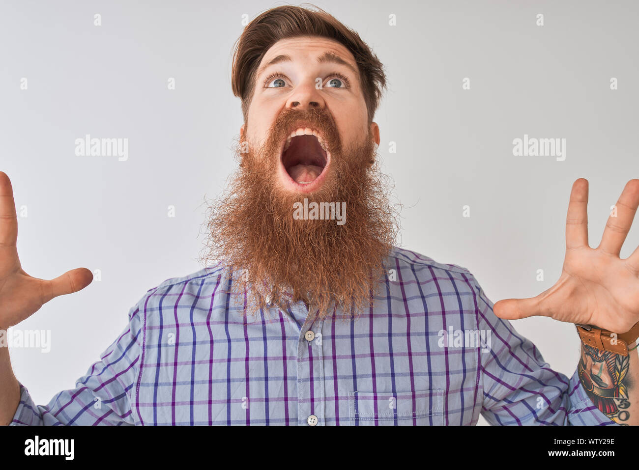 Redhead irish man listening to music using wireless earphones over ...