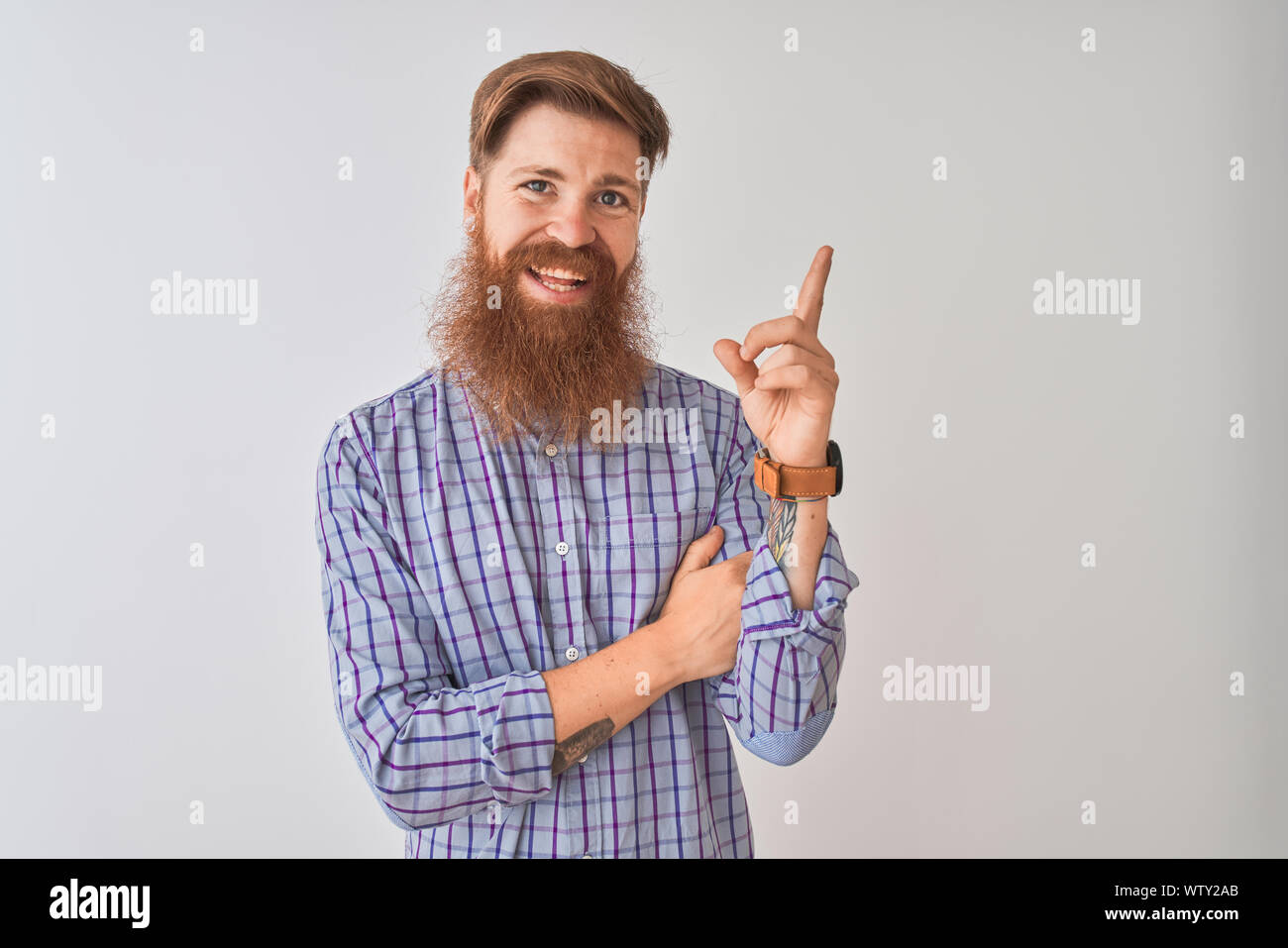 Young redhead irish man wearing casual shirt standing over isolated ...