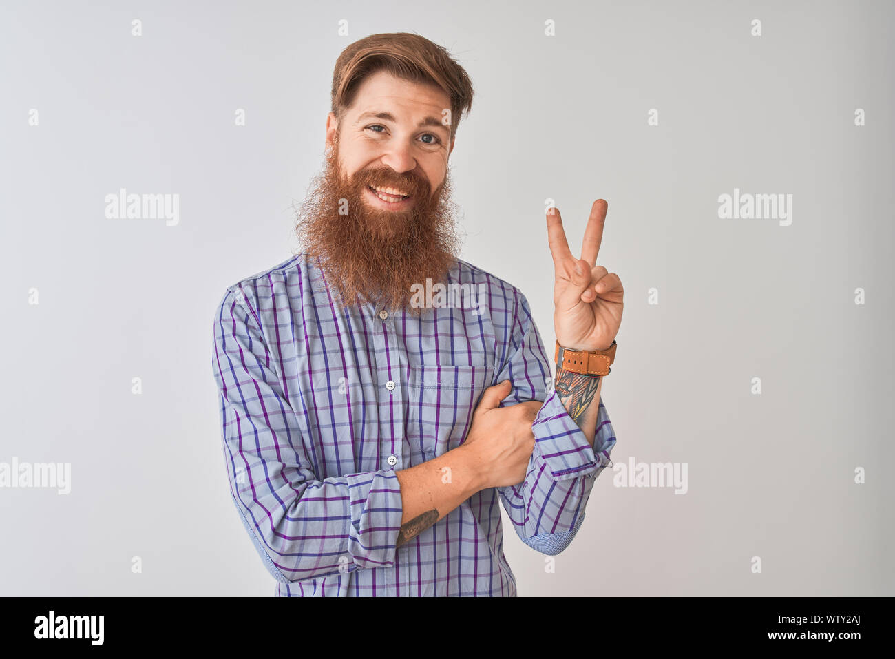 Young redhead irish man wearing casual shirt standing over isolated ...