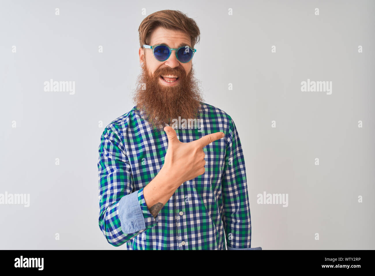 Young redhead irish man wearing casual shirt and sunglasses over ...