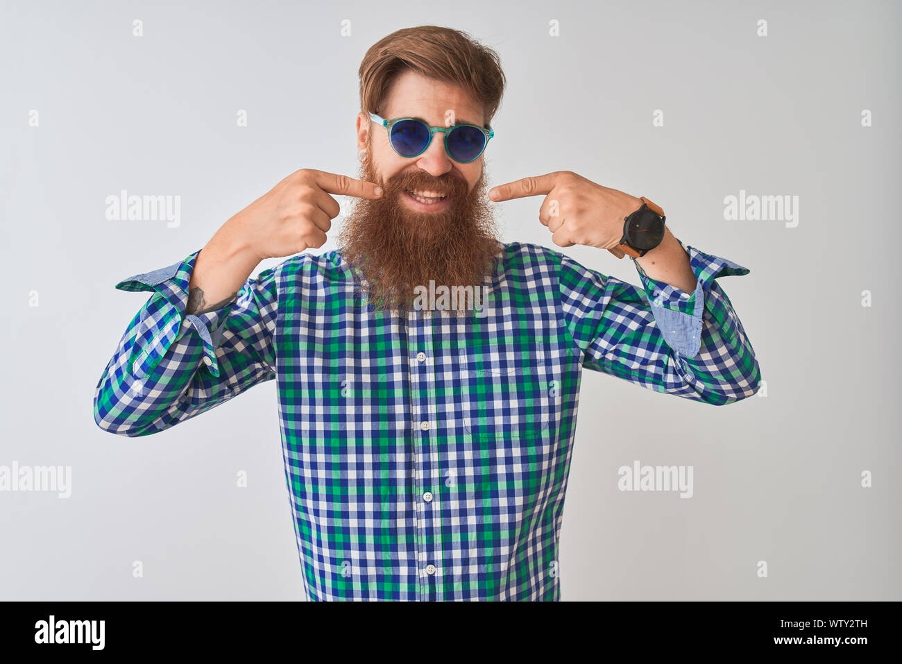 Young redhead irish man wearing casual shirt and sunglasses over ...
