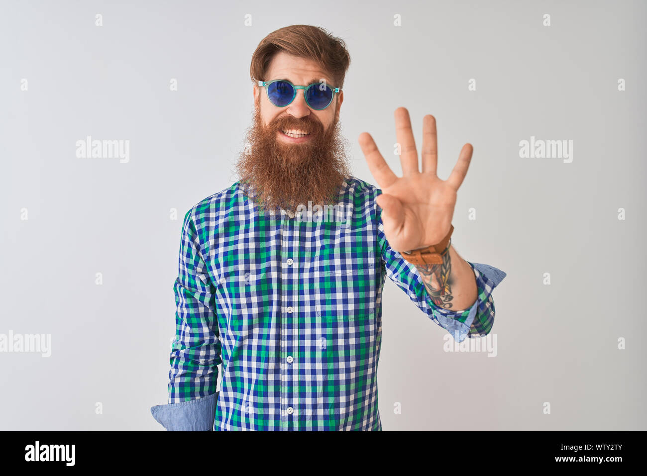 Young redhead irish man wearing casual shirt and sunglasses over ...