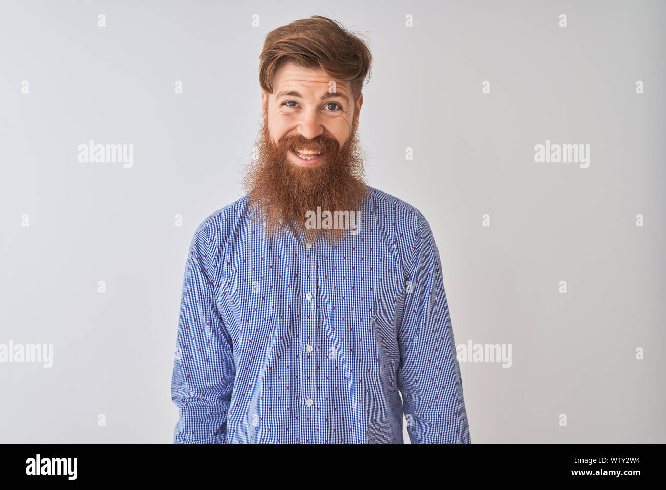 Young redhead irish man wearing casual shirt standing over isolated ...