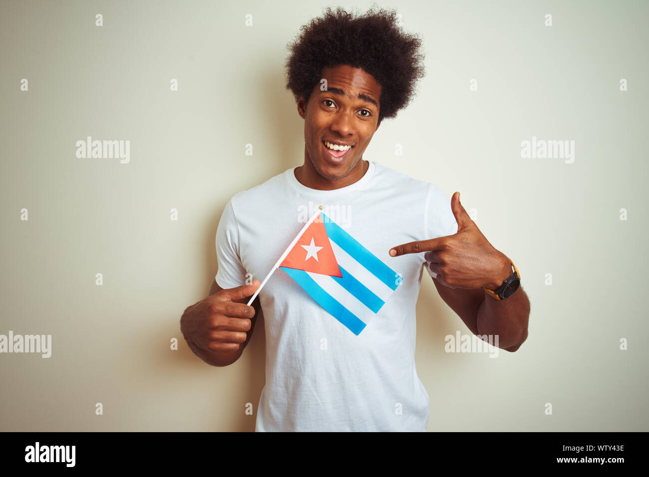 Young african american man holding Cuba Cuban flag standing over ...