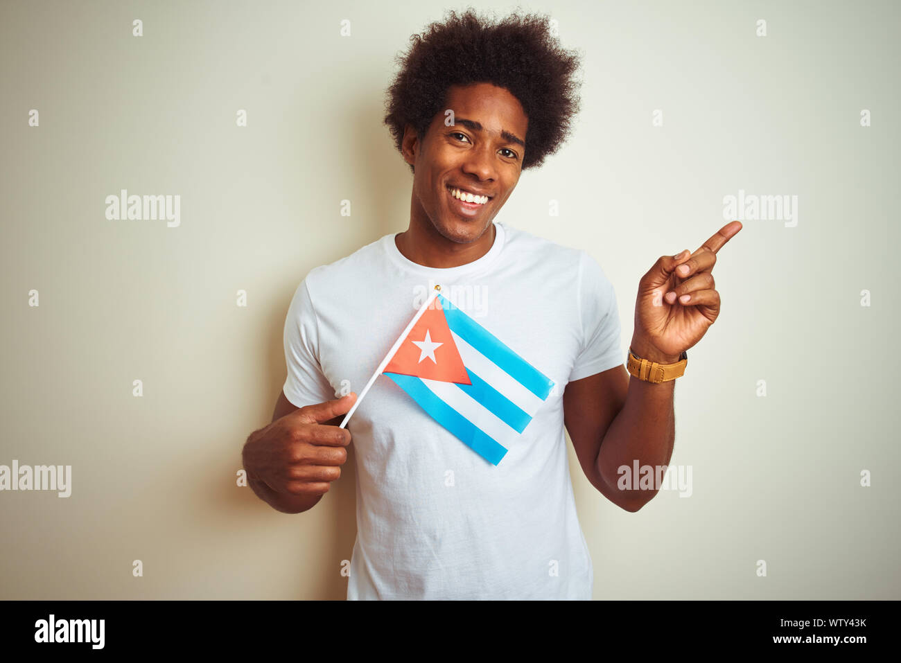 Young african american man holding Cuba Cuban flag standing over ...