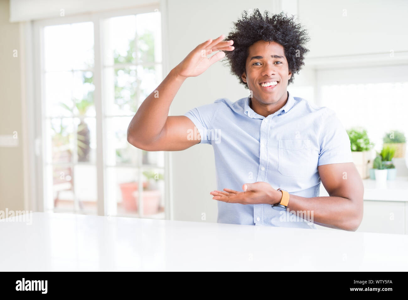 African American business man gesturing with hands showing big and ...