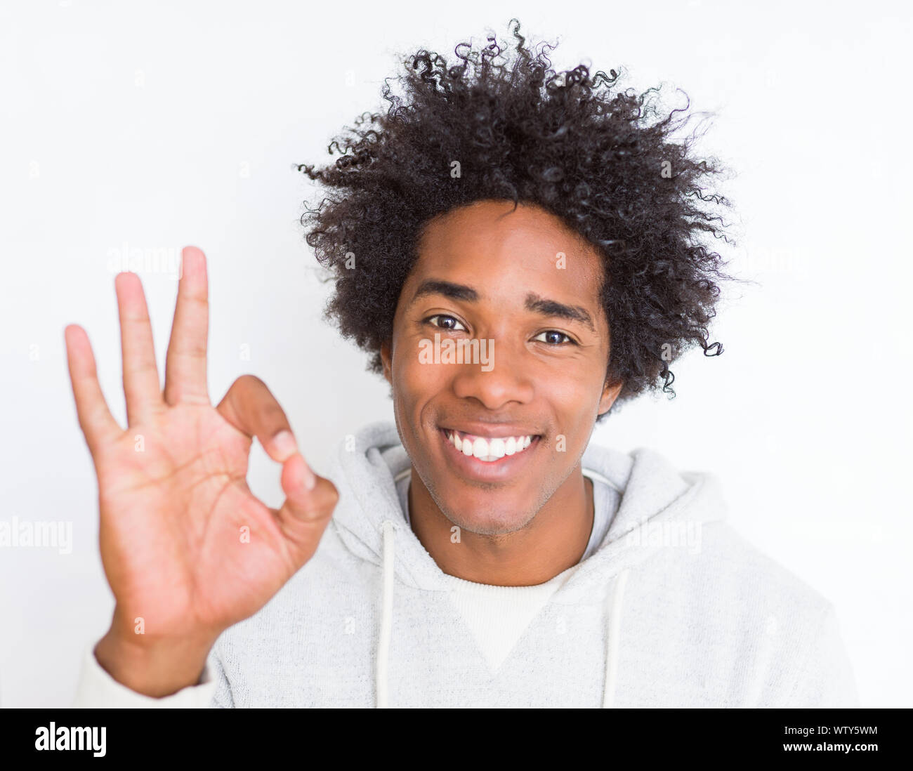 African American man over white isolated background doing ok sign with ...