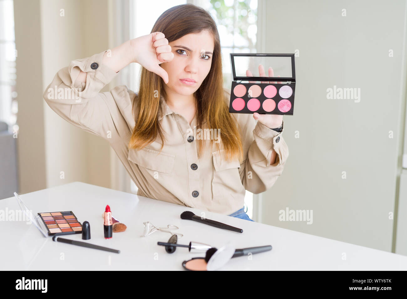 Applying makeup angry hi-res stock photography and images - Alamy