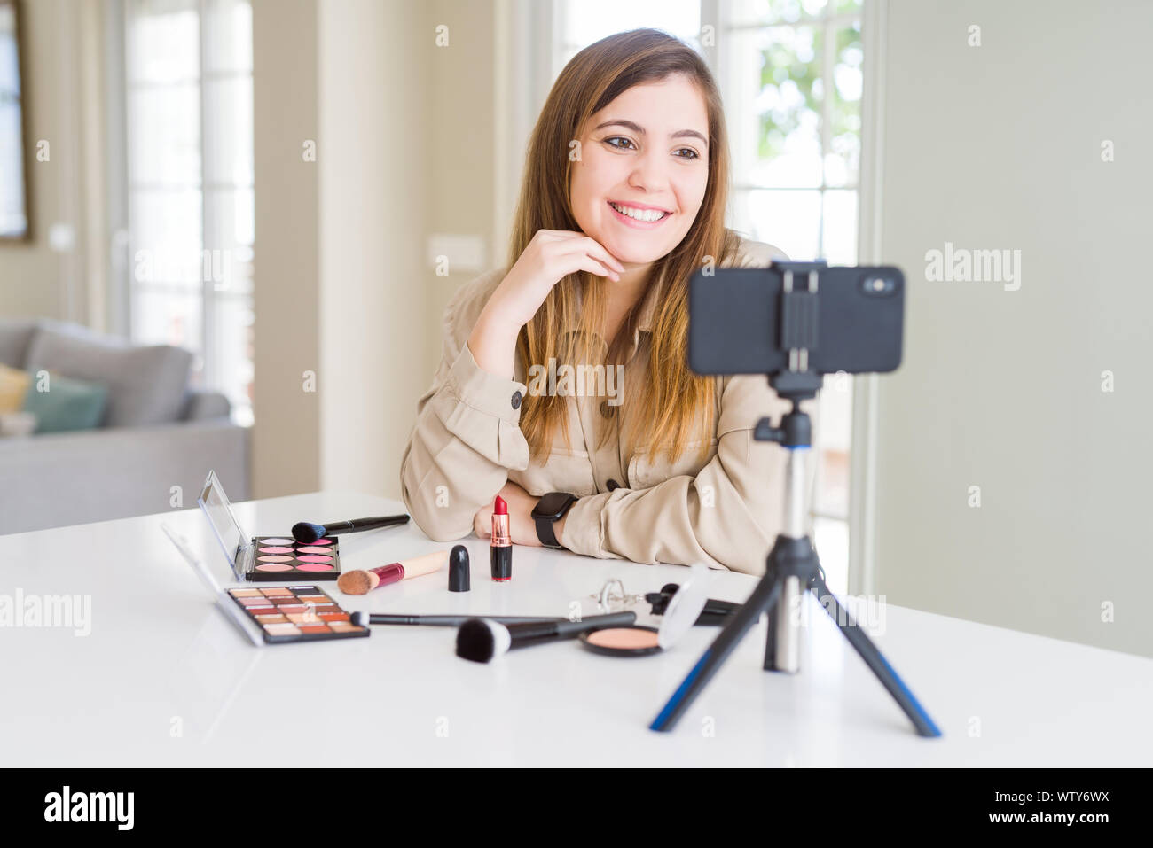 Beautiful young influencer woman recording make up video tutorial ...