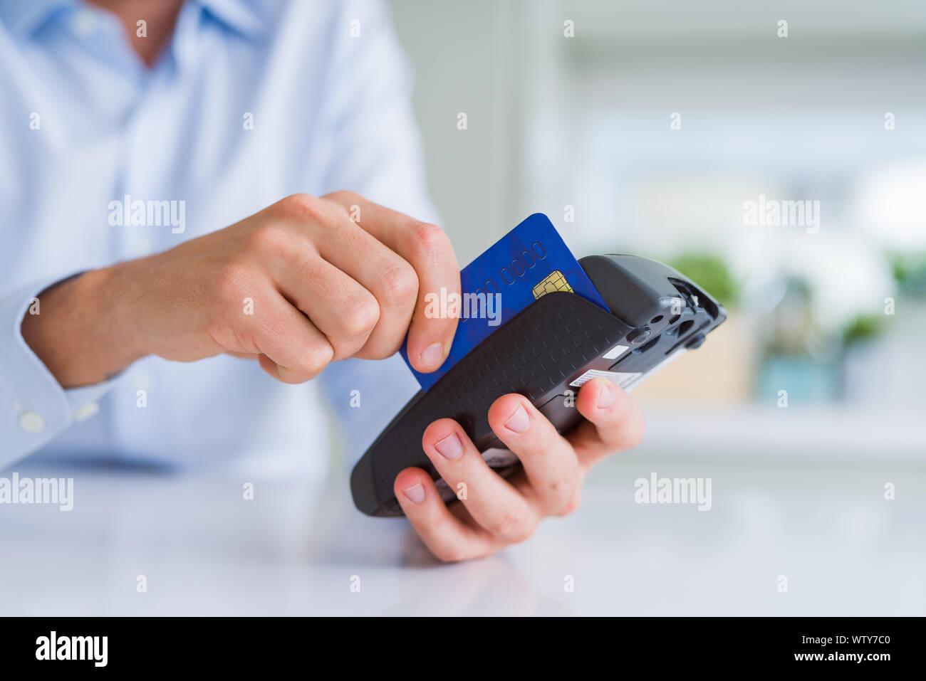 Close up of man hands holding pos terminal Stock Photo - Alamy