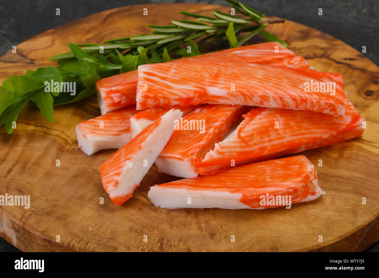 Crab stick surimi over wooden board Stock Photo - Alamy