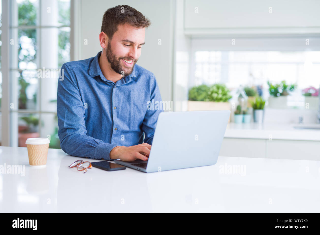 Handsome business man working using computer laptop and smiling Stock ...