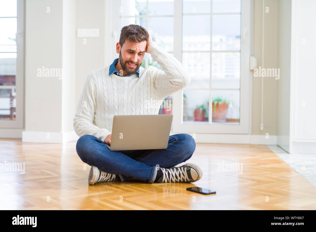 Handsome man wearing working using computer laptop stressed with hand ...