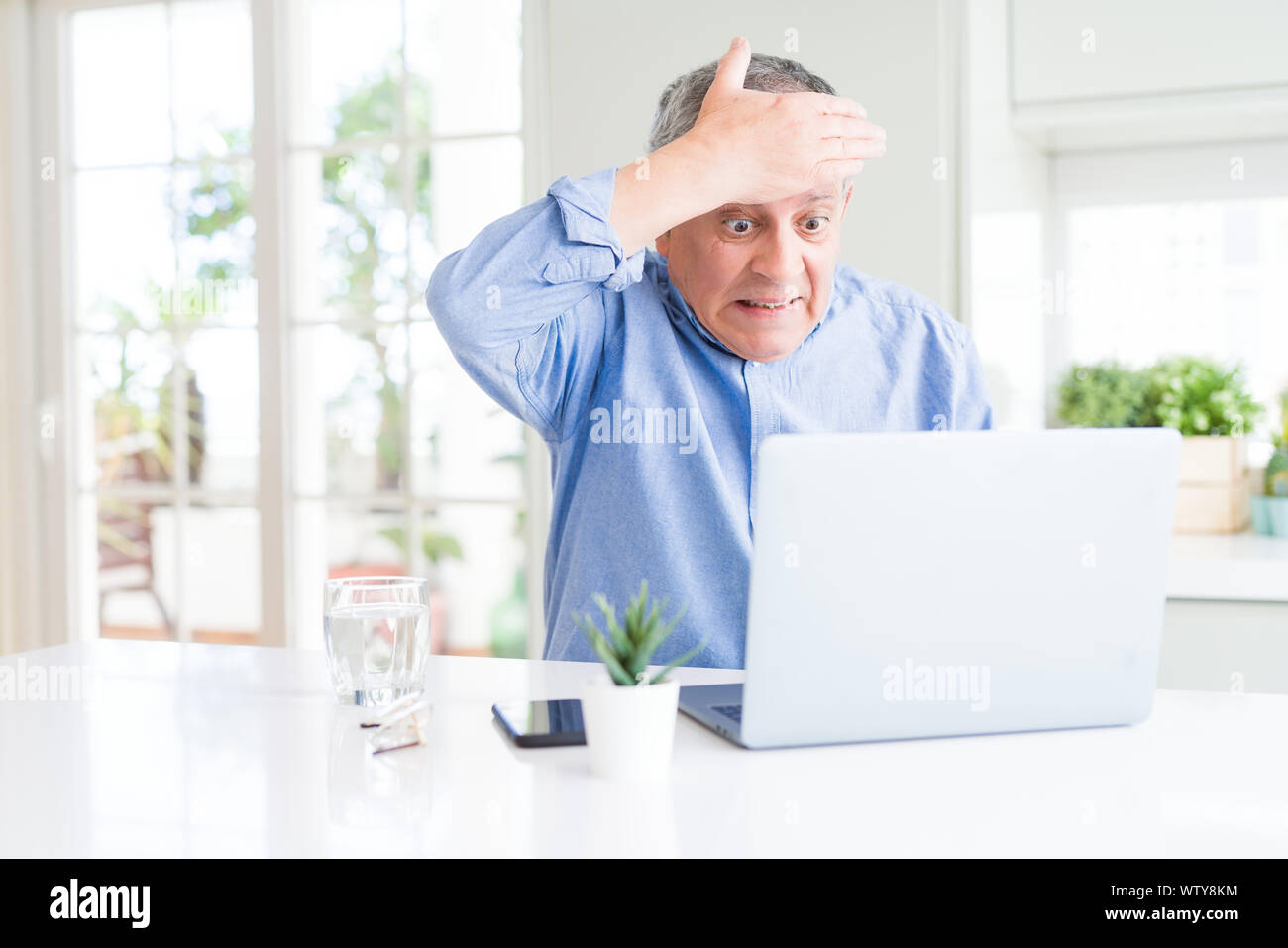 Handsome senior man using computer laptop working on internet stressed ...
