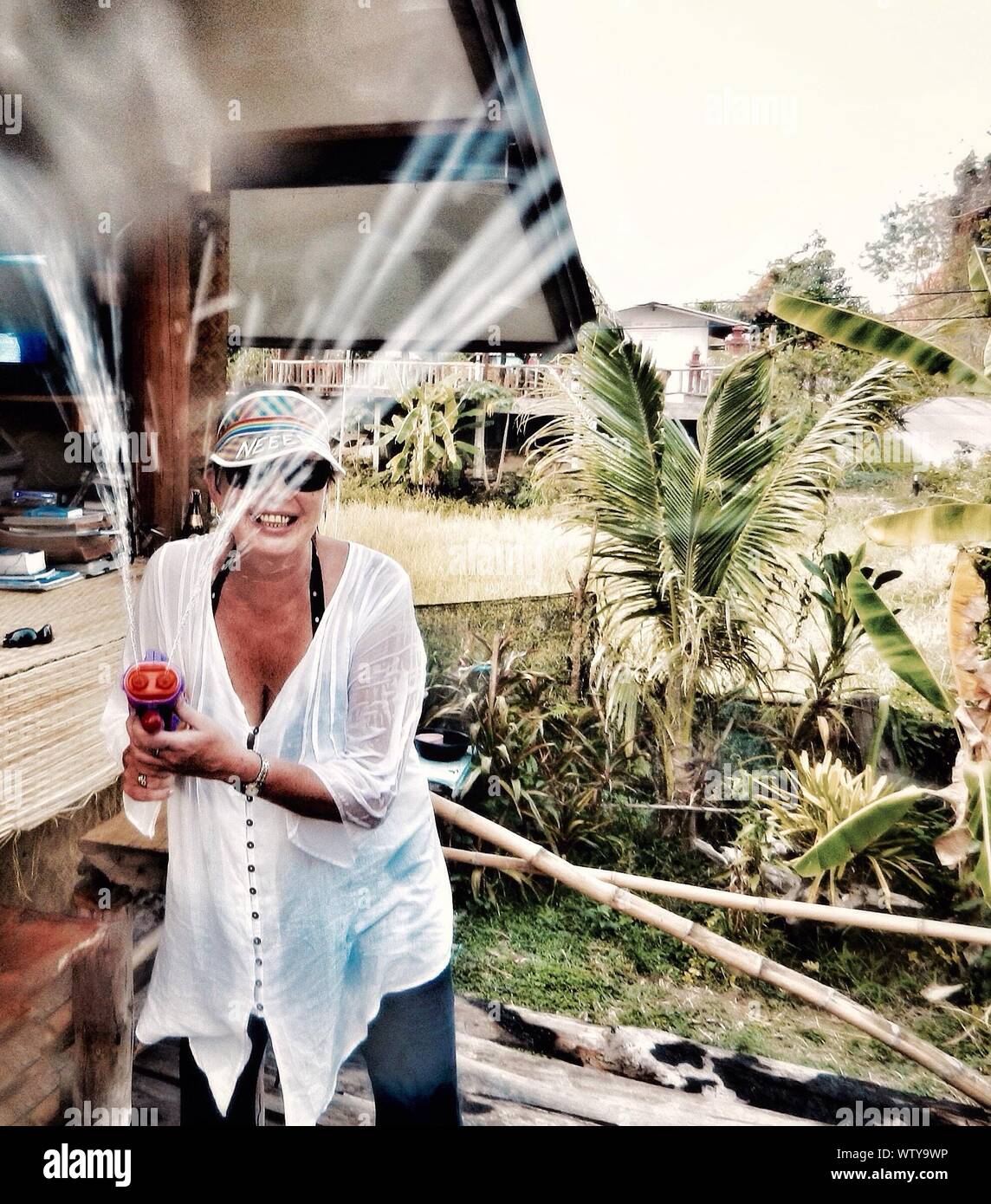 Man using water hose hi-res stock photography and images - Alamy