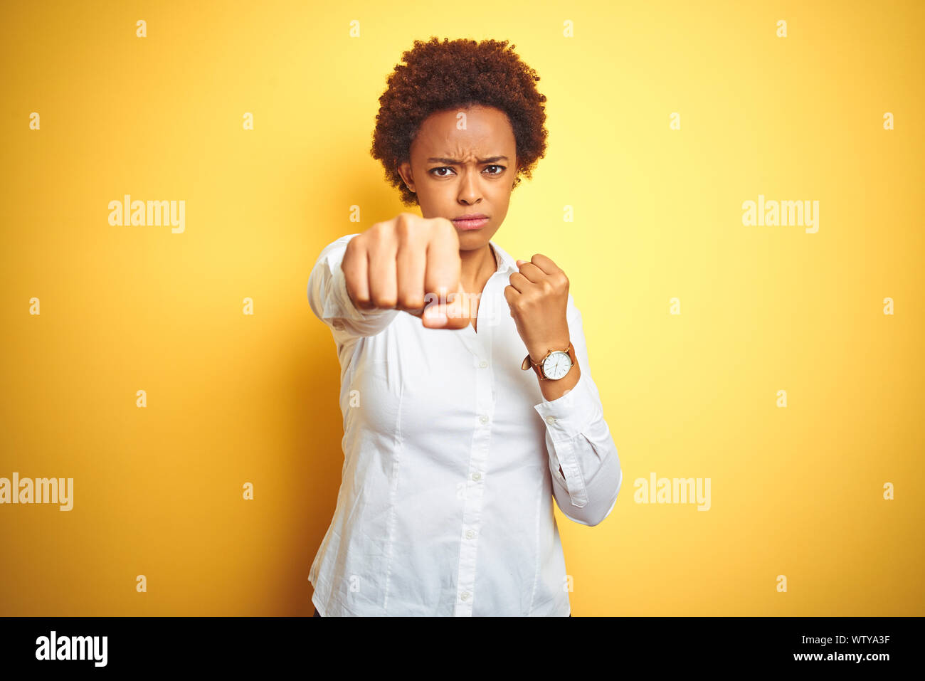 African american business woman over isolated yellow background ...
