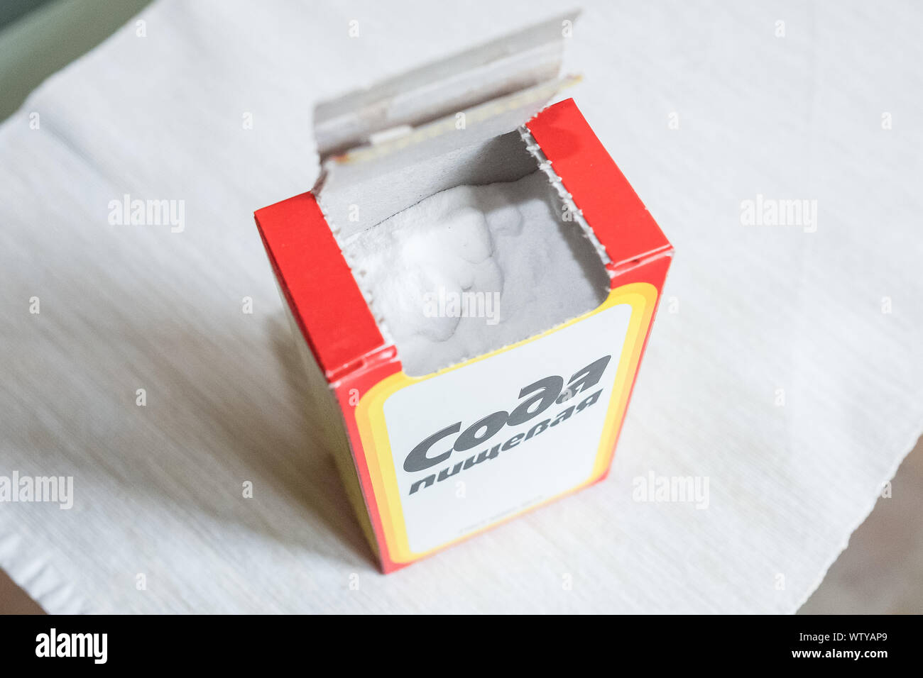 Baking soda in a paper box. Branded packaging of soda in the kitchen ...