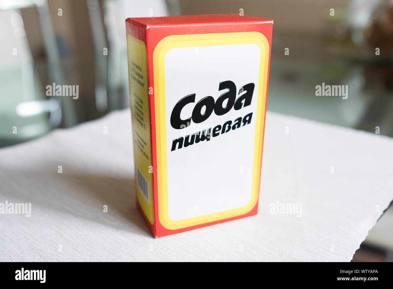 Baking soda in a paper box. Branded packaging of soda in the kitchen ...