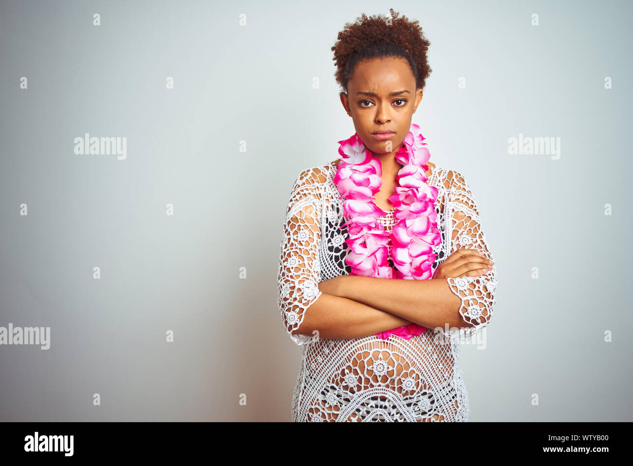 Young african american woman with afro hair wearing flower hawaiian lei ...