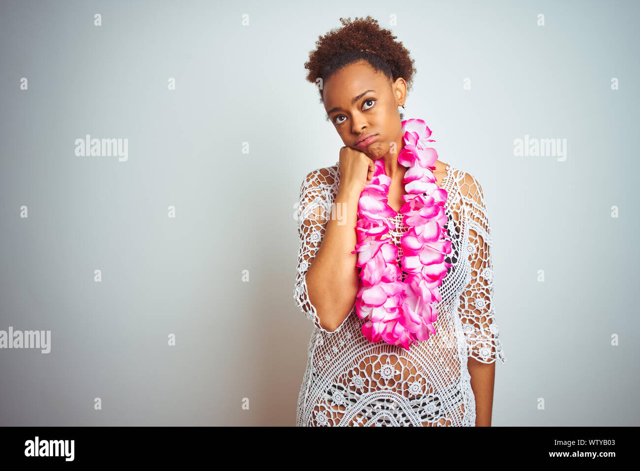 Young african american woman with afro hair wearing flower hawaiian lei ...