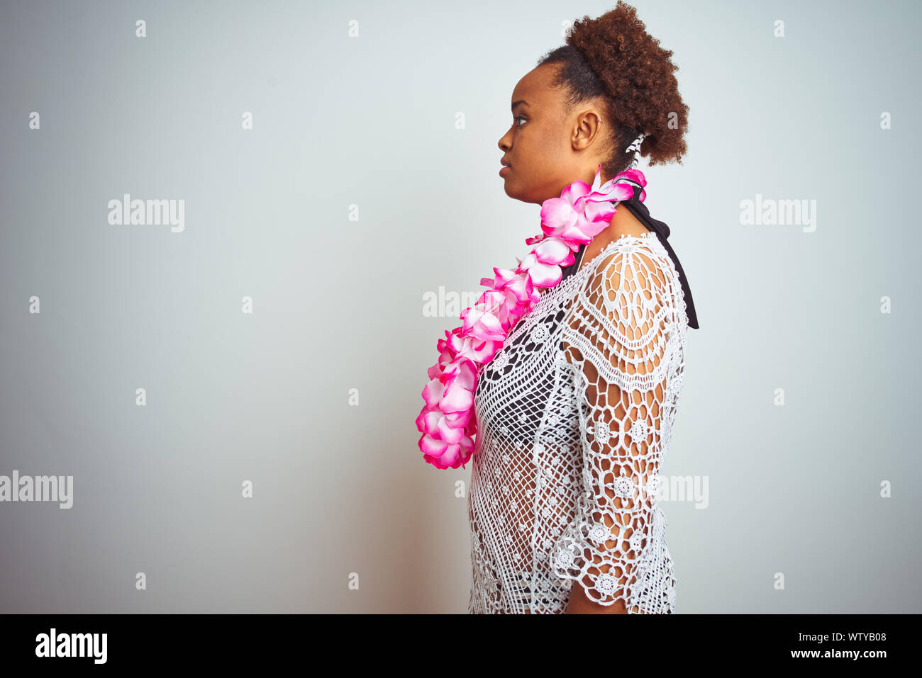 Young african american woman with afro hair wearing flower hawaiian lei ...