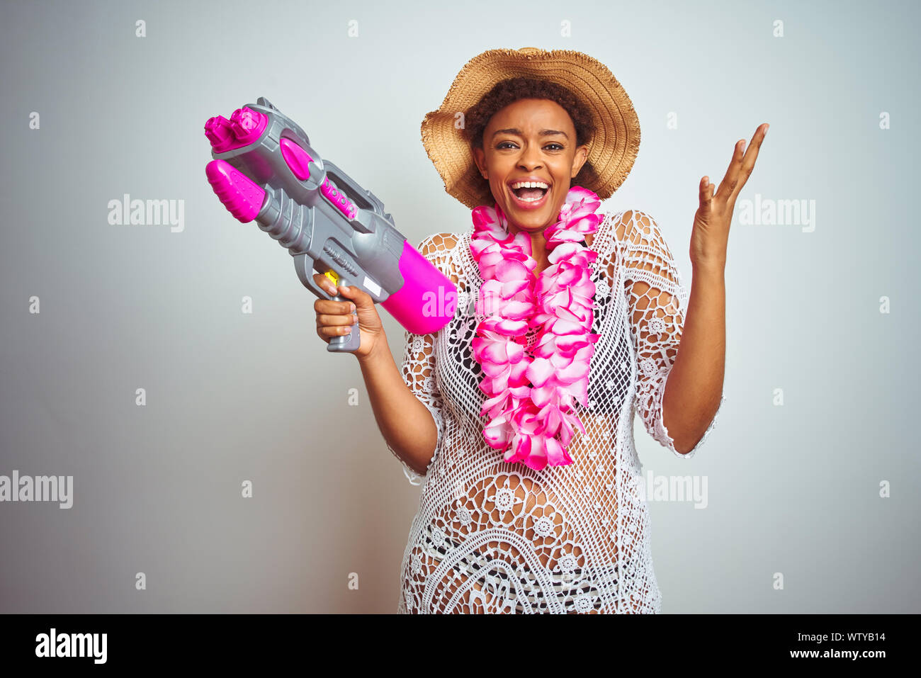 Young african american woman with afro hair wearing flower hawaiian lei ...