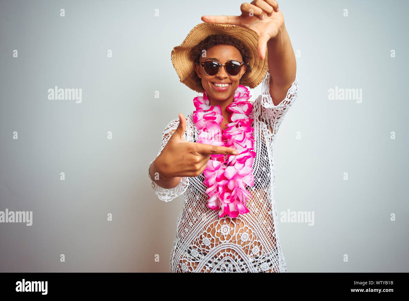 Young african american woman with afro hair wearing flower hawaiian lei ...