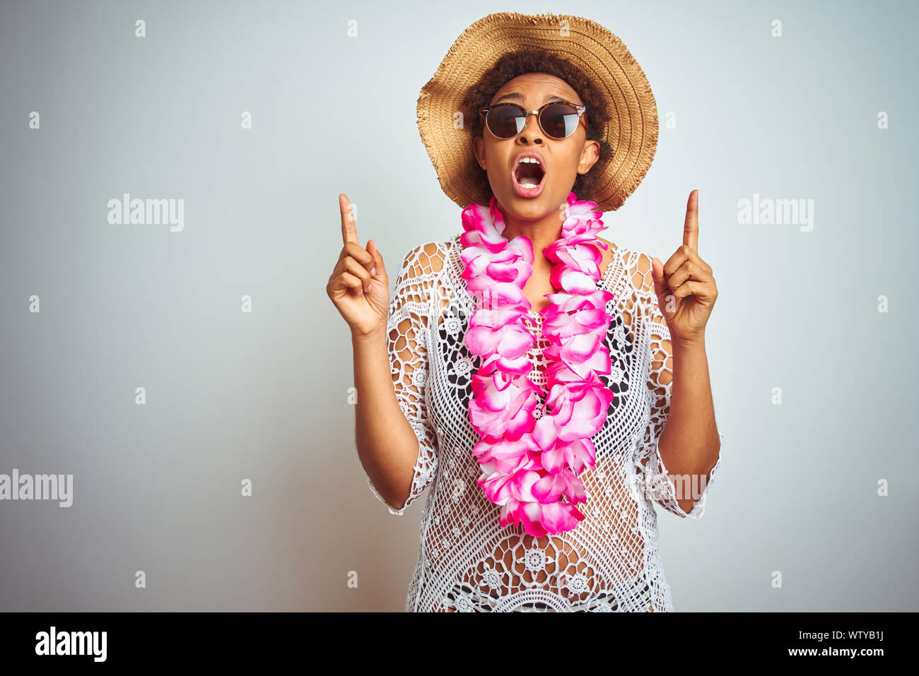 Young african american woman with afro hair wearing flower hawaiian lei ...