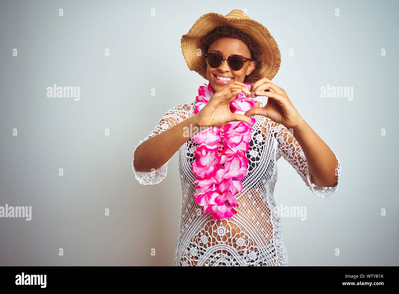 Young african american woman with afro hair wearing flower hawaiian lei ...