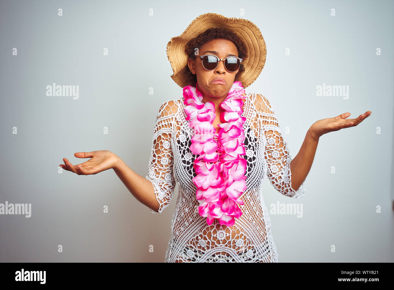 Young african american woman with afro hair wearing flower hawaiian lei ...