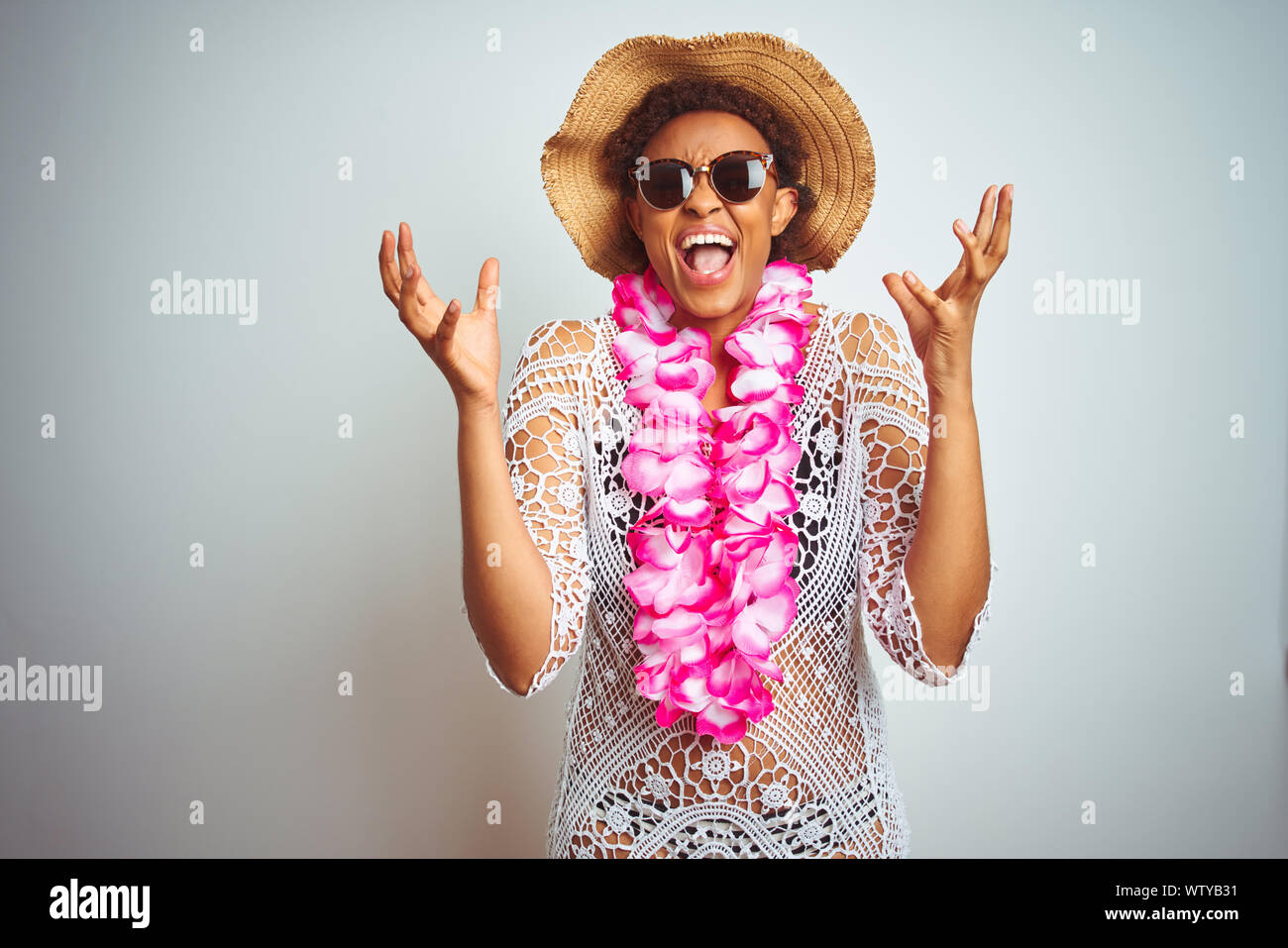 Young african american woman with afro hair wearing flower hawaiian lei ...