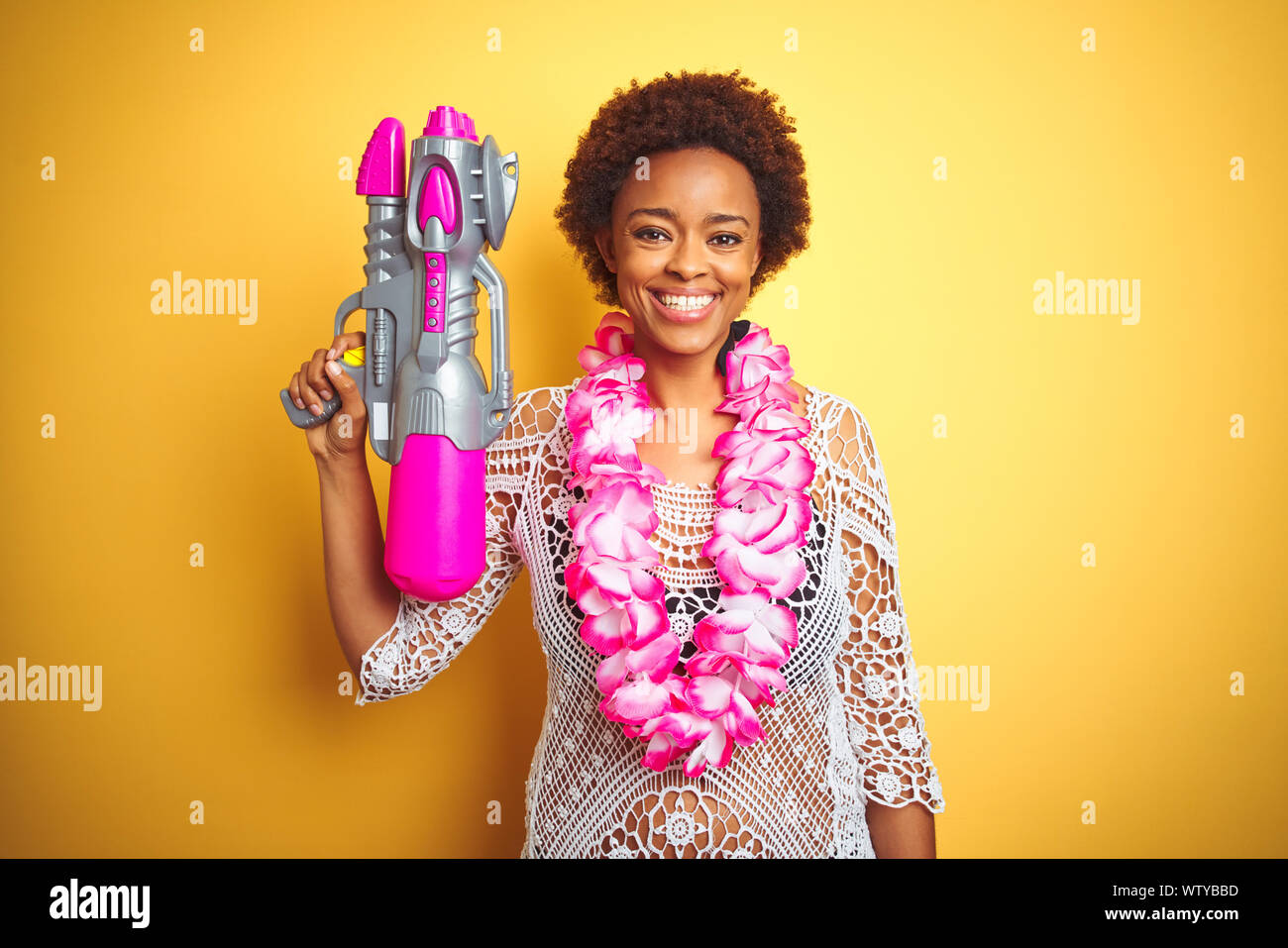 Young african american woman with afro hair wearing flower hawaiian lei ...