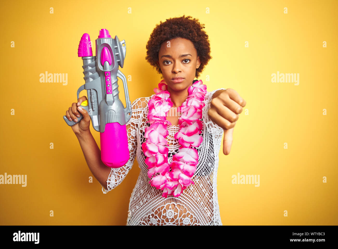 Young african american woman with afro hair wearing flower hawaiian lei ...