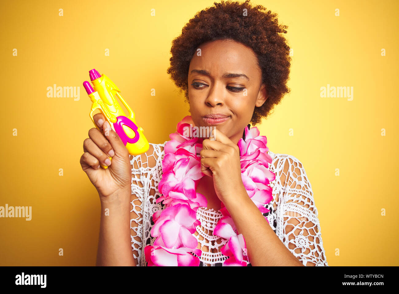 Young african american woman with afro hair wearing flower hawaiian lei ...