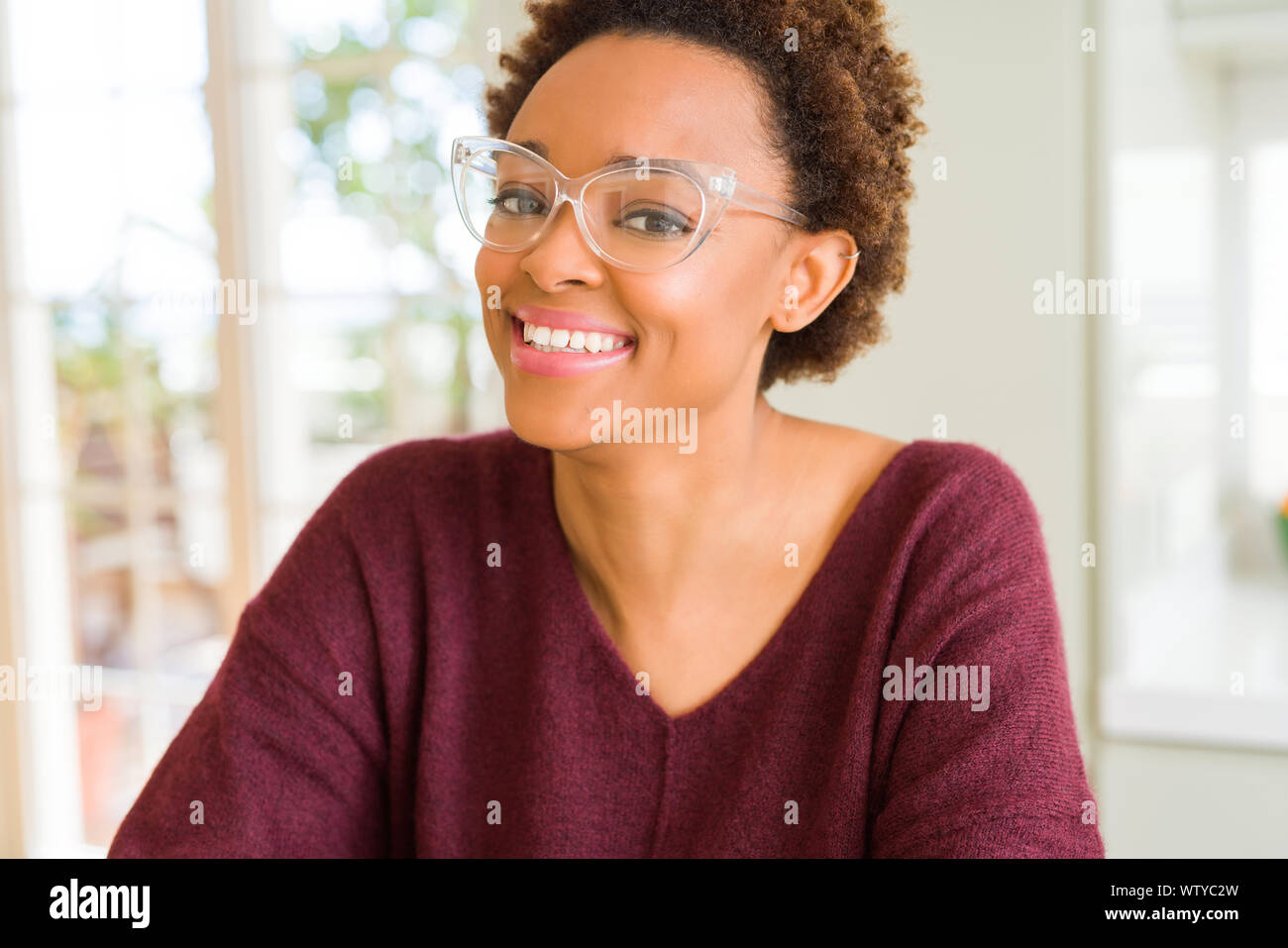 Beautiful young african woman with afro hair wearing glasses Stock ...