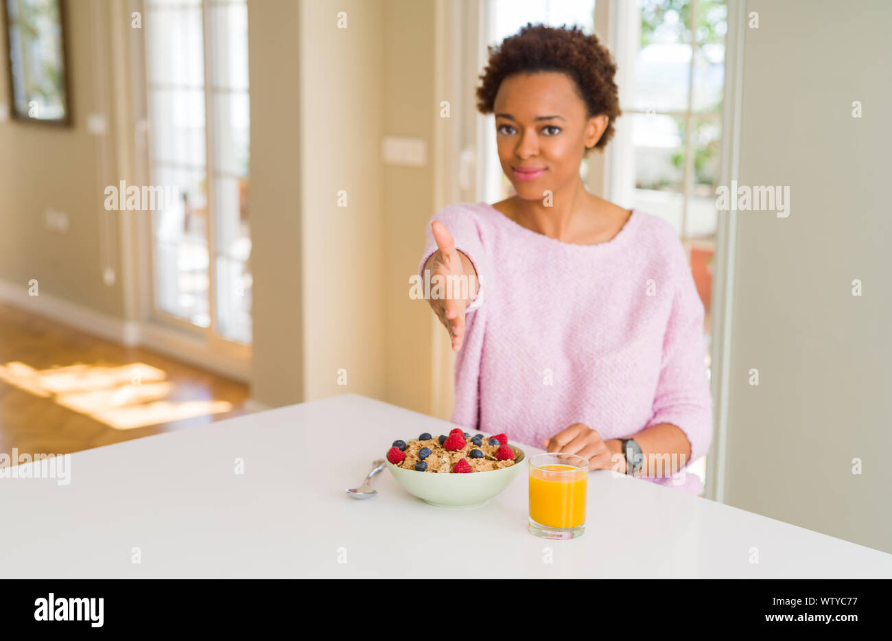 Young african american woman having healthy breakfast in the morning at ...