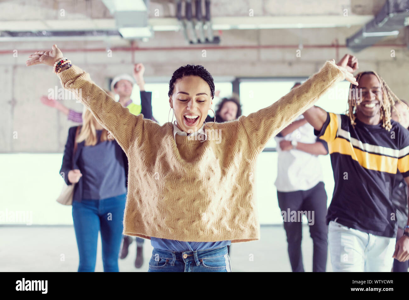happy multiethnic business team dancing during moving in at new ...