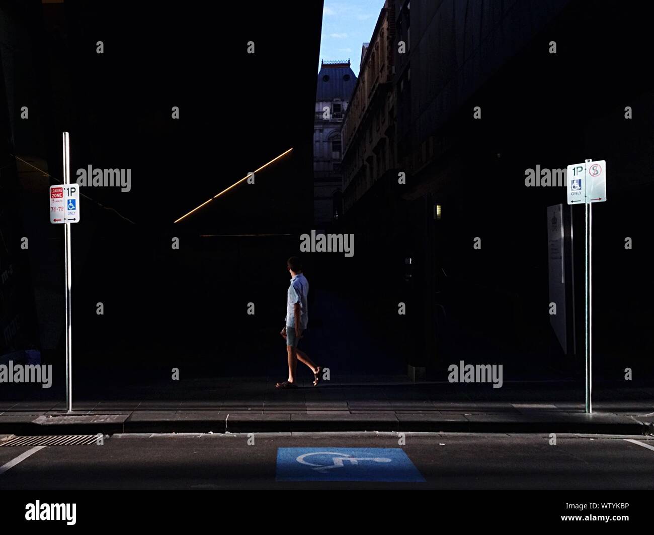 Side View Of Man Walking On Sidewalk Stock Photo - Alamy