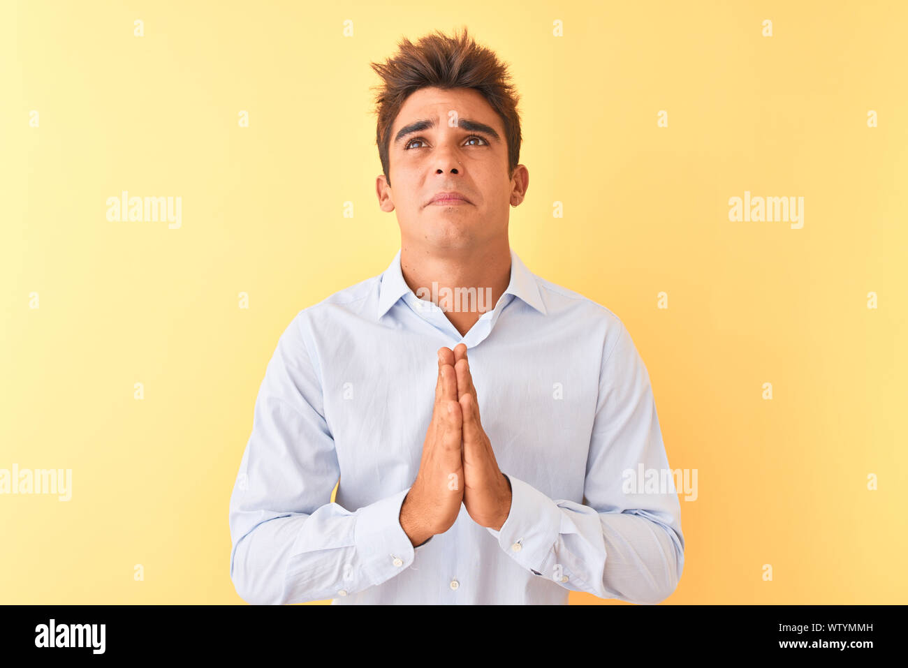 Young handsome businessman wearing elegant shirt over isolated yellow ...