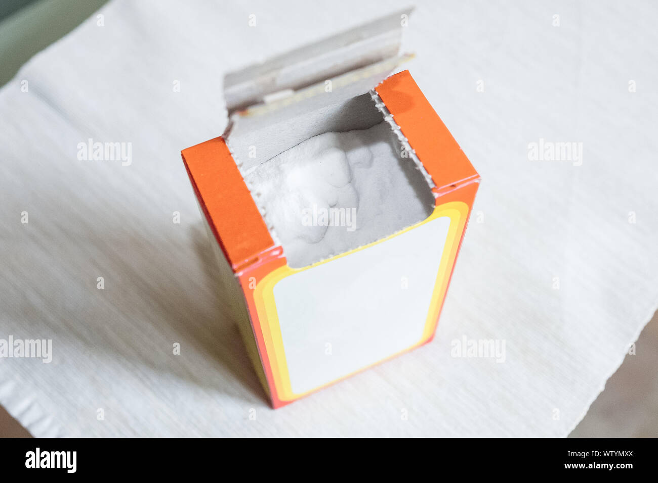 Baking soda in a paper box. Branded packaging of soda in the kitchen ...