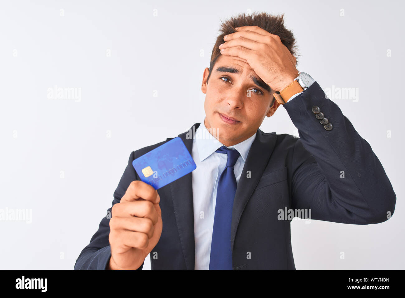 Young handsome businessman wearing suit holding credit card over ...