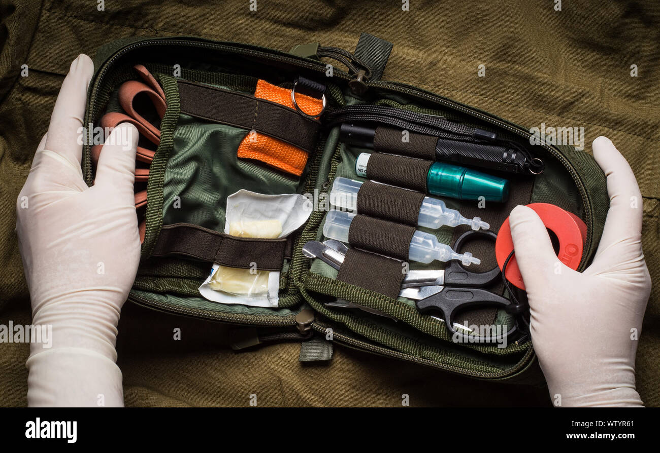 Pocket military outdoor first aid kit on khaki canvas background Stock ...