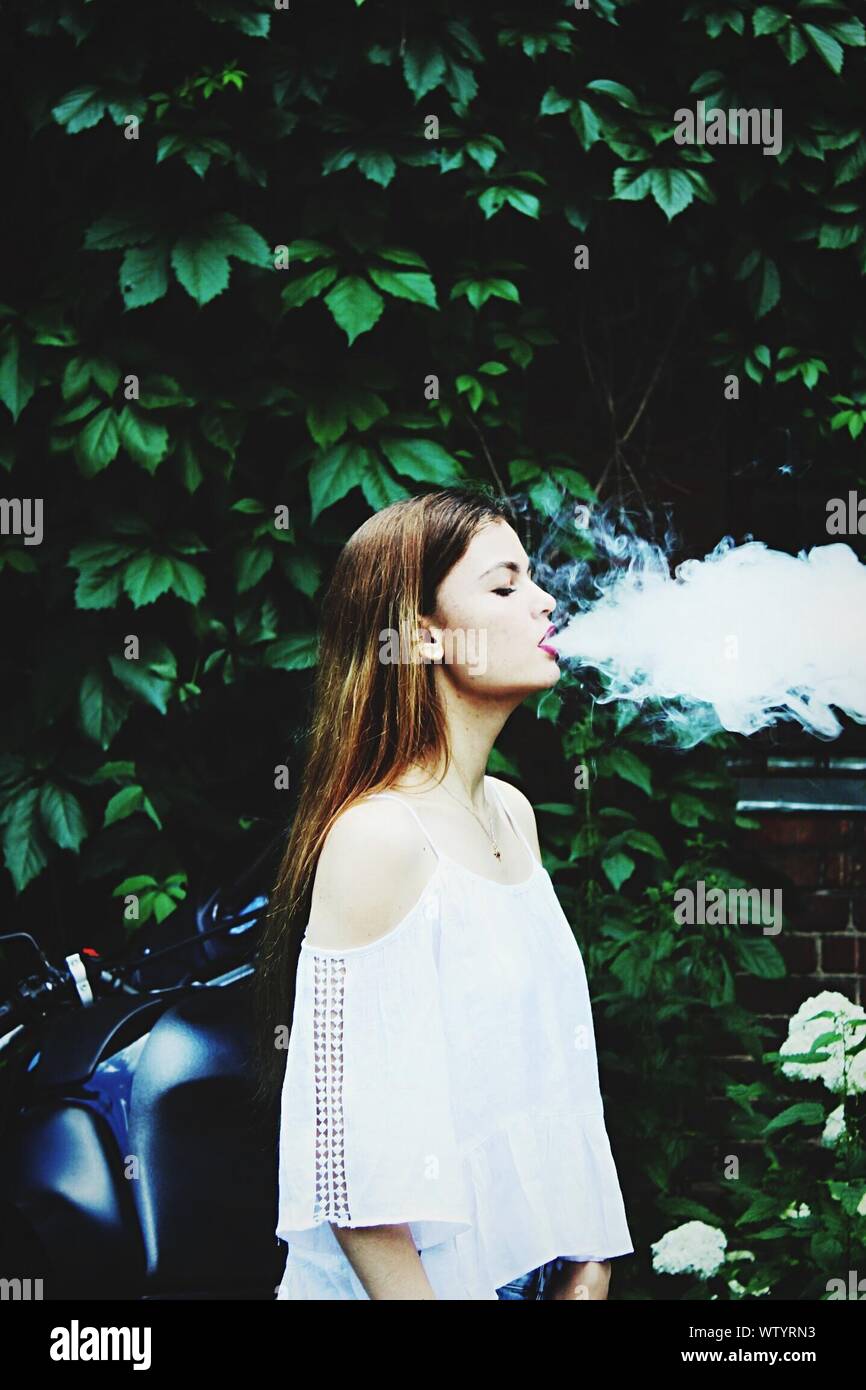 Woman exhaling smoke hi-res stock photography and images - Alamy