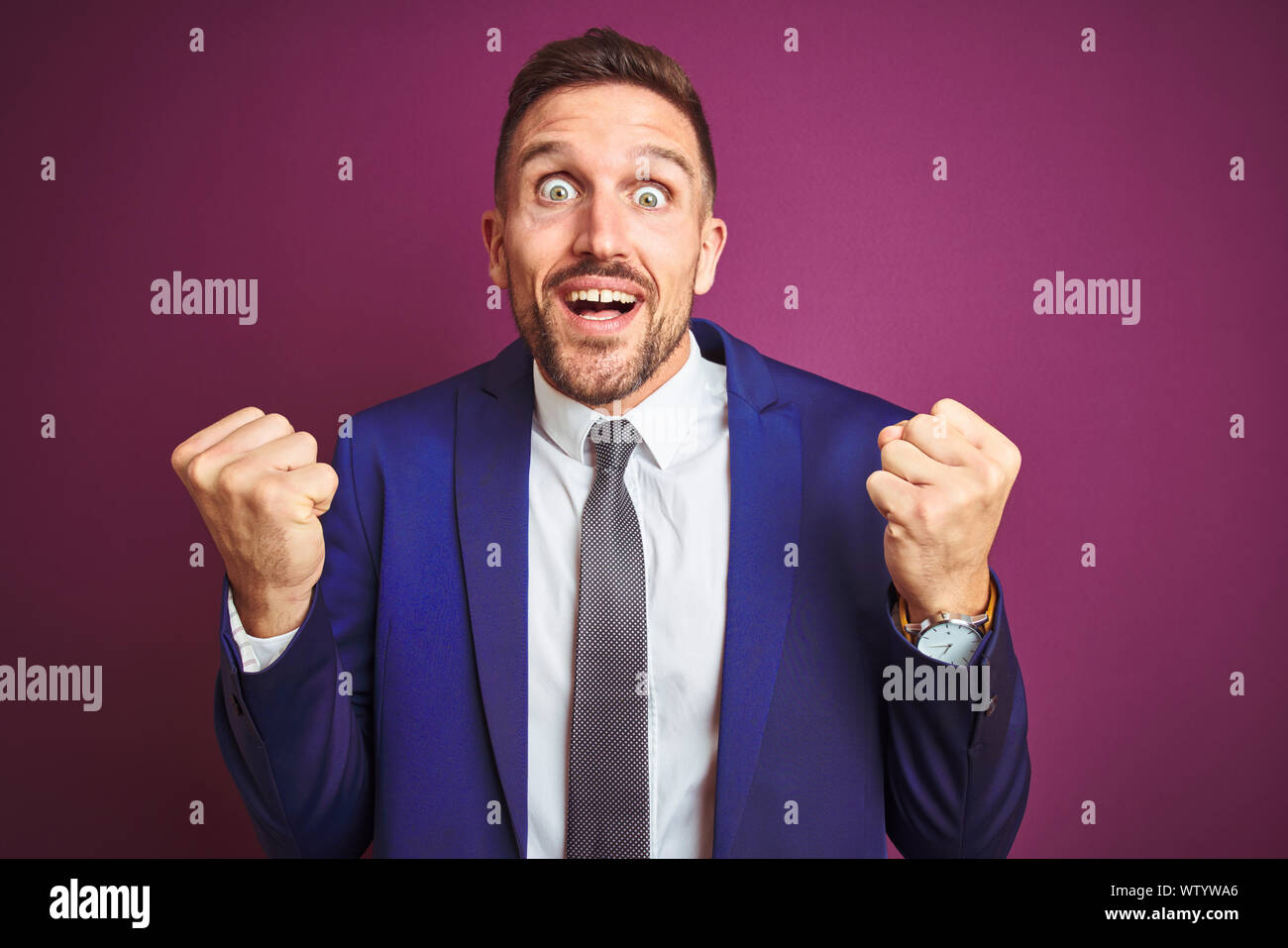 Young handsome business man over purple isolated background celebrating surprised and amazed for ...
