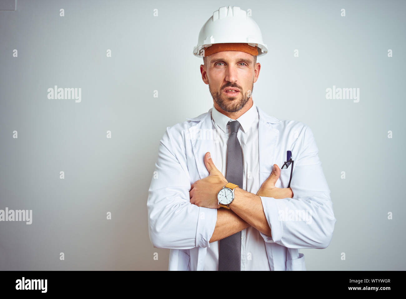 Young handsome engineer man wearing safety helmet over isolated ...